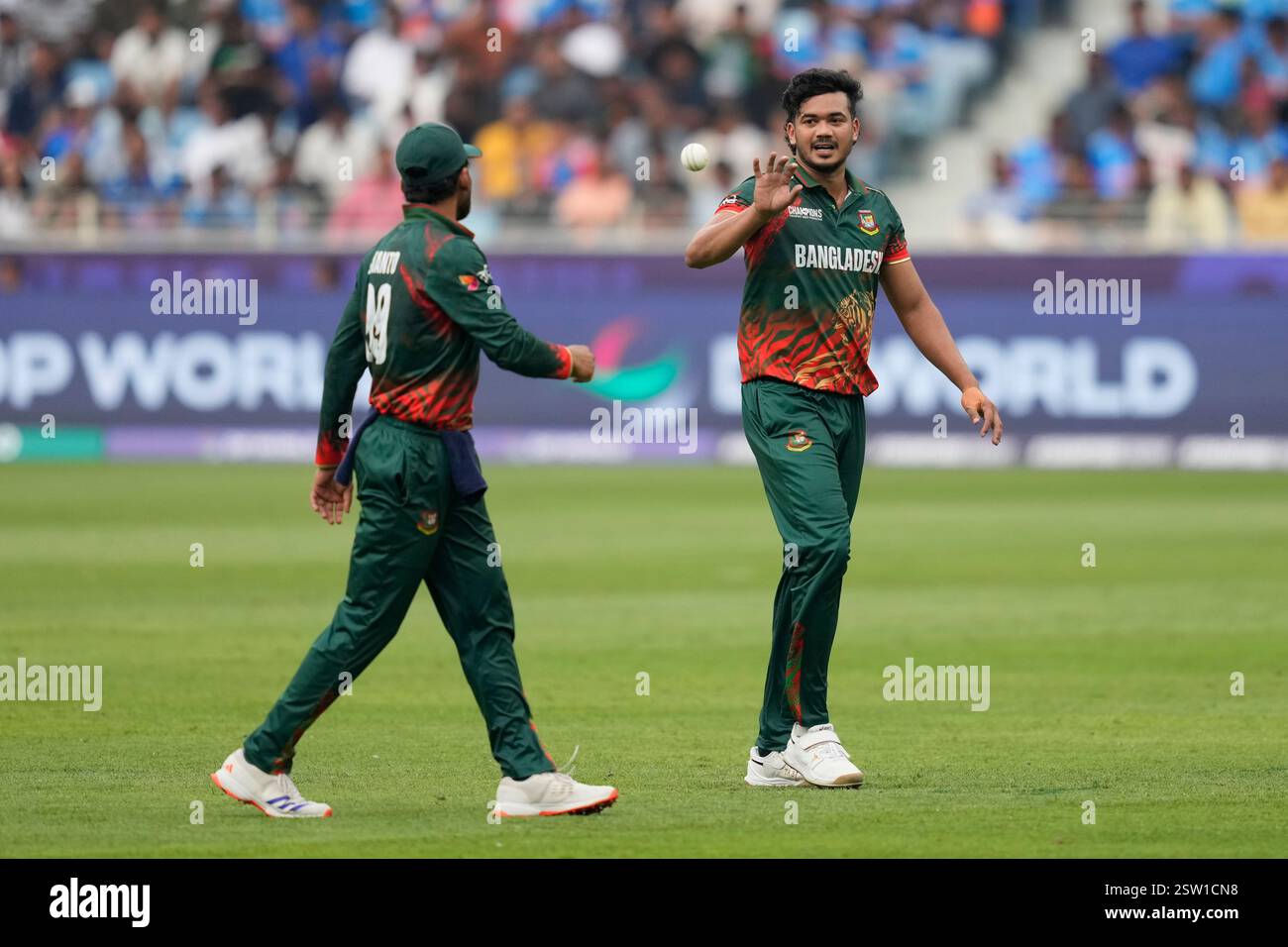 Bangladesh's Taskin Ahmed, right, prepares to bowl his next delivery during the ICC Champions ...