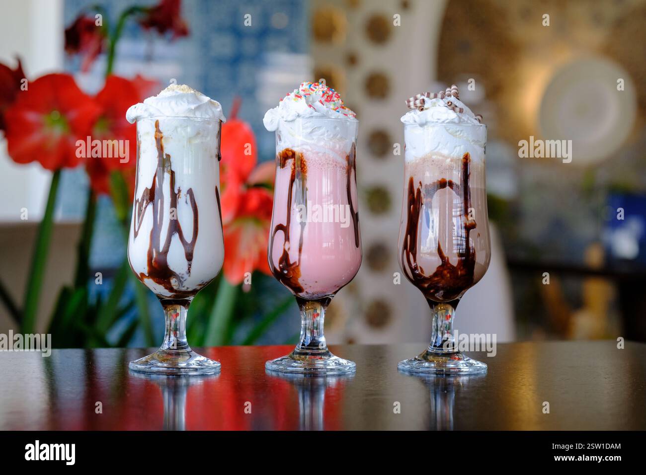 Three creamy delicious milkshake variations in elegant glasses Stock ...