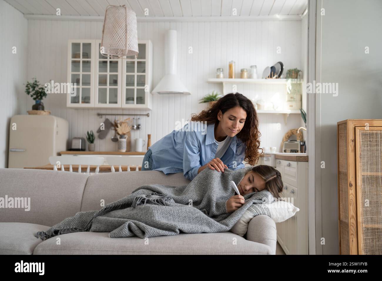 Staying home with sick child. Loving caring mother comforting ill kid ...