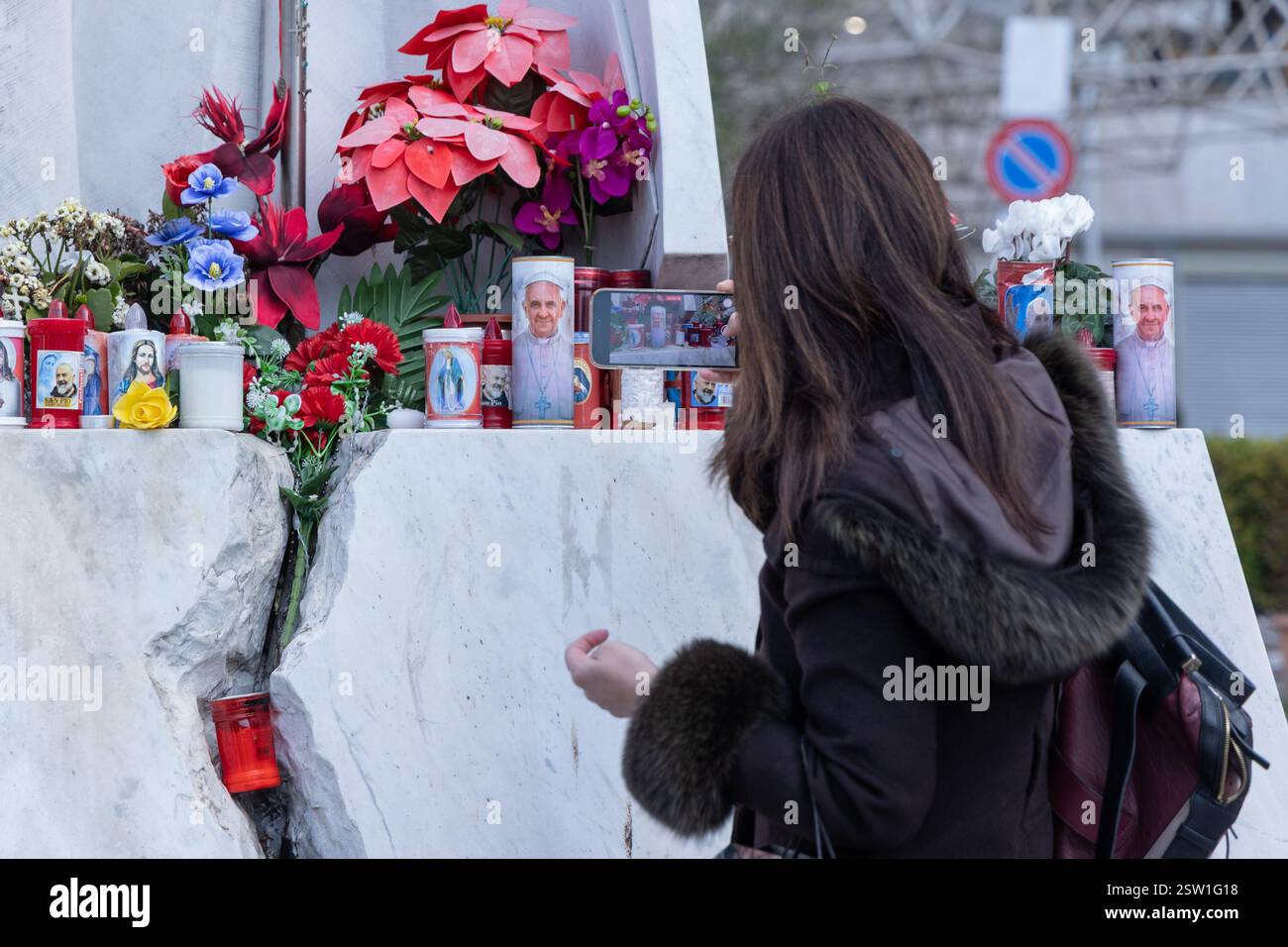 Rome, Italy. 20th Feb, 2025. A woman takes a photo of the lights ...