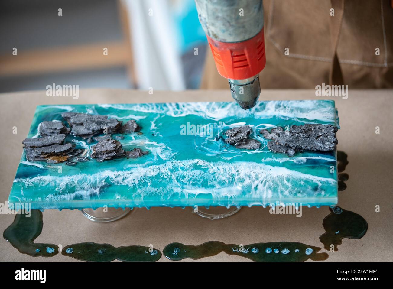 Artist working with liquid epoxy resin hi-res stock photography and ...