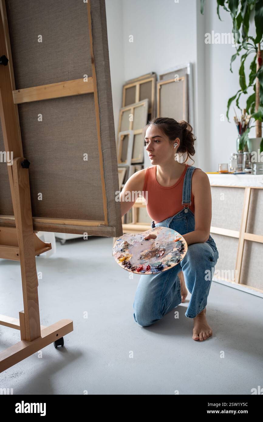 Focused woman artist devotes to process of drawing, engaged in hobby ...