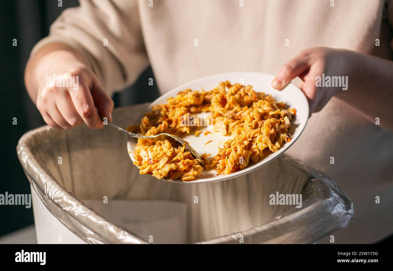 Woman throwing away bio trash with food leftovers into garbage. Compost ...