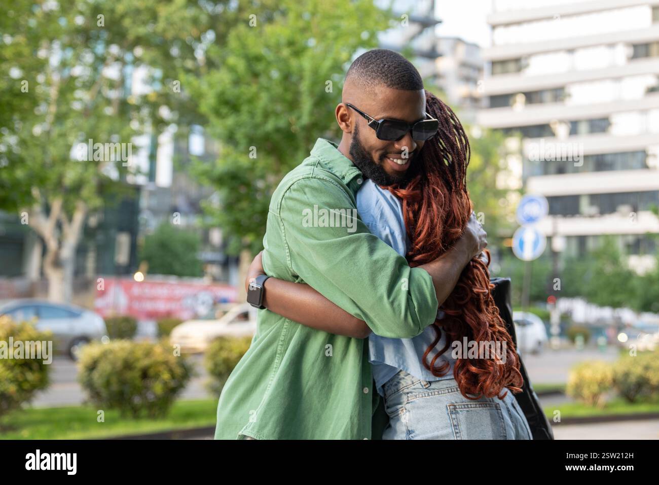 Happy African American couple, students hugging each other goodbye ...