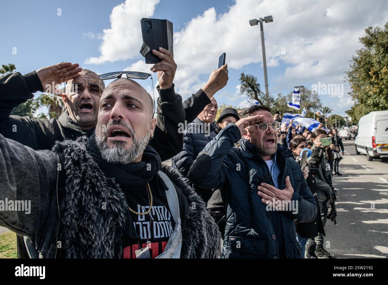 Israeli citizens salute while shouting “We’re sorry!” as the bodies of ...