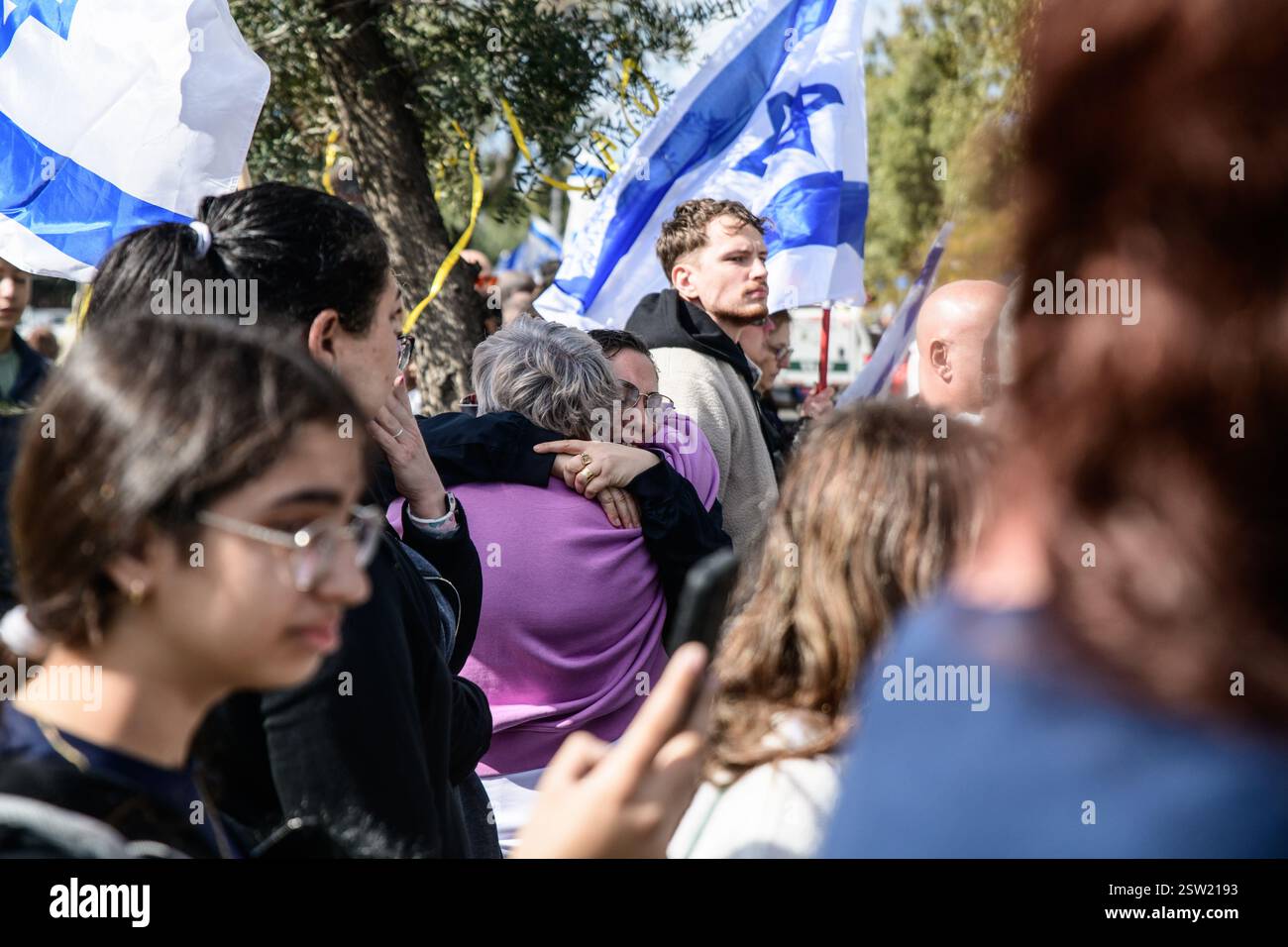 Israelis cry and hug as the hostages bodies reach the Abu Kabir ...