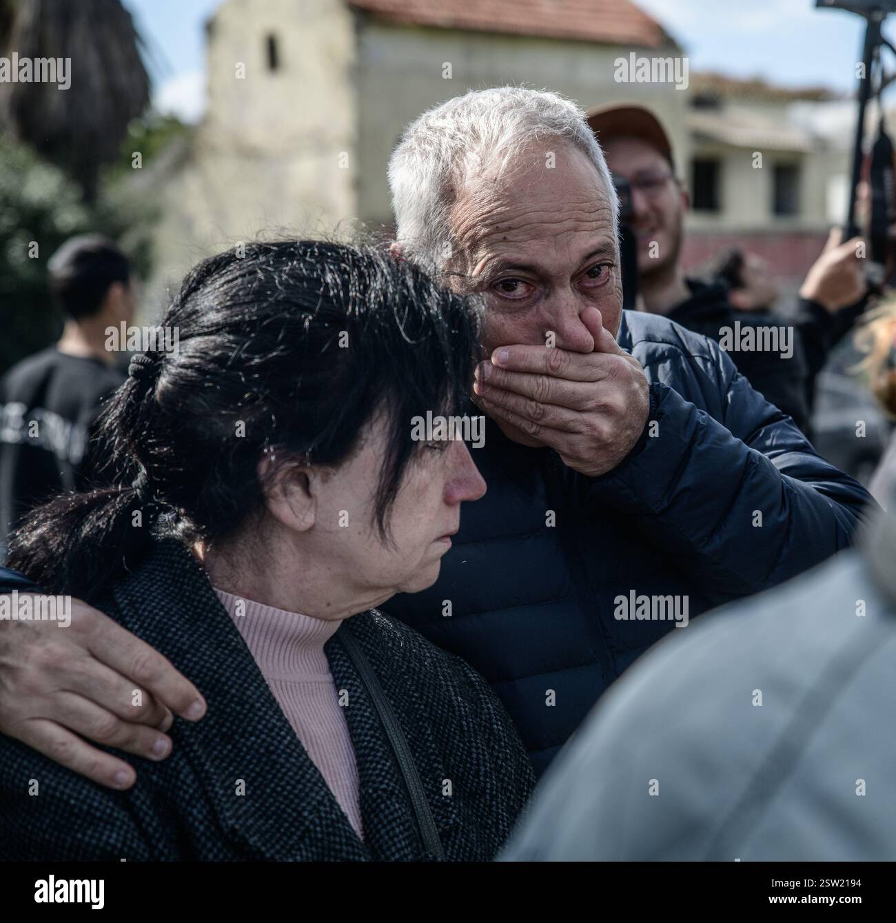 An Israeli man hold back his tears as the bodies of Israeli hostages ...