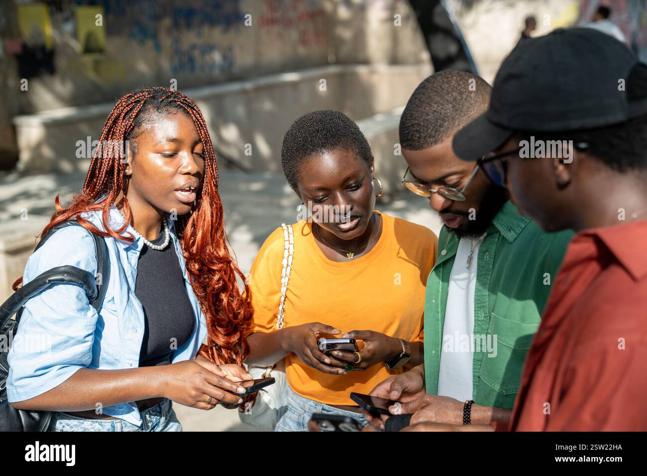 Interested serious group of black students communicate by sharing study ...