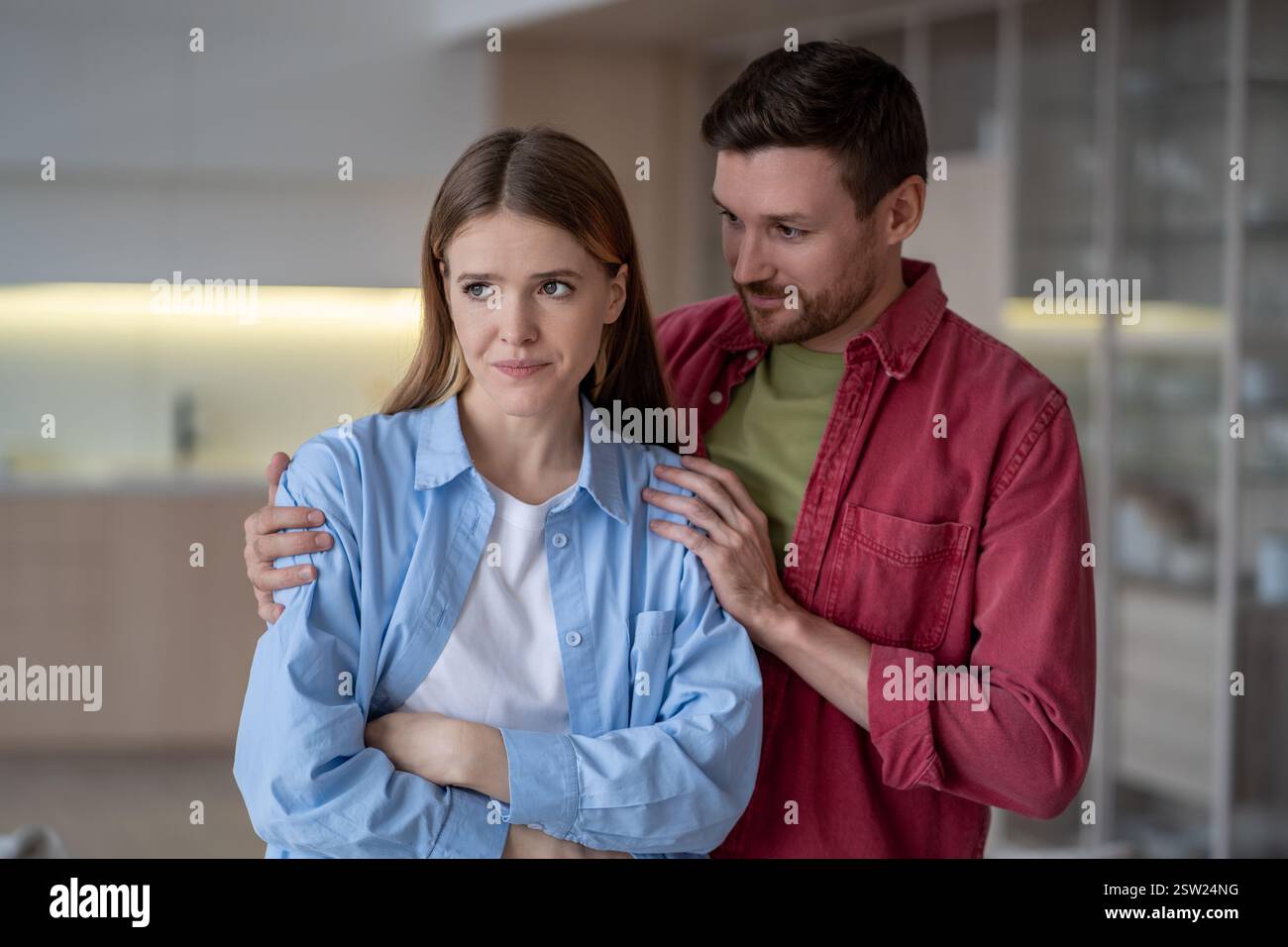 Upset and angry woman with PMS and husband calms and hugs her, provides ...