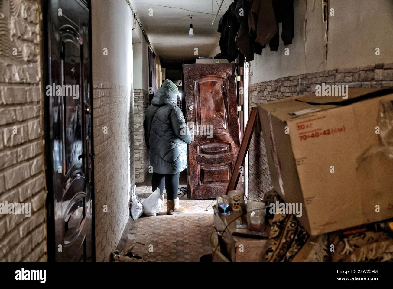ODESA, UKRAINE - FEBRUARY 20, 2025 - A woman is in the corridor of a ...