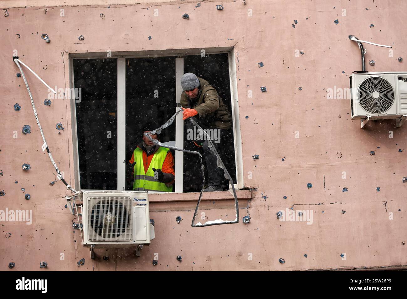 ODESA, UKRAINE - FEBRUARY 20, 2025 - Municipal workers repair a window ...