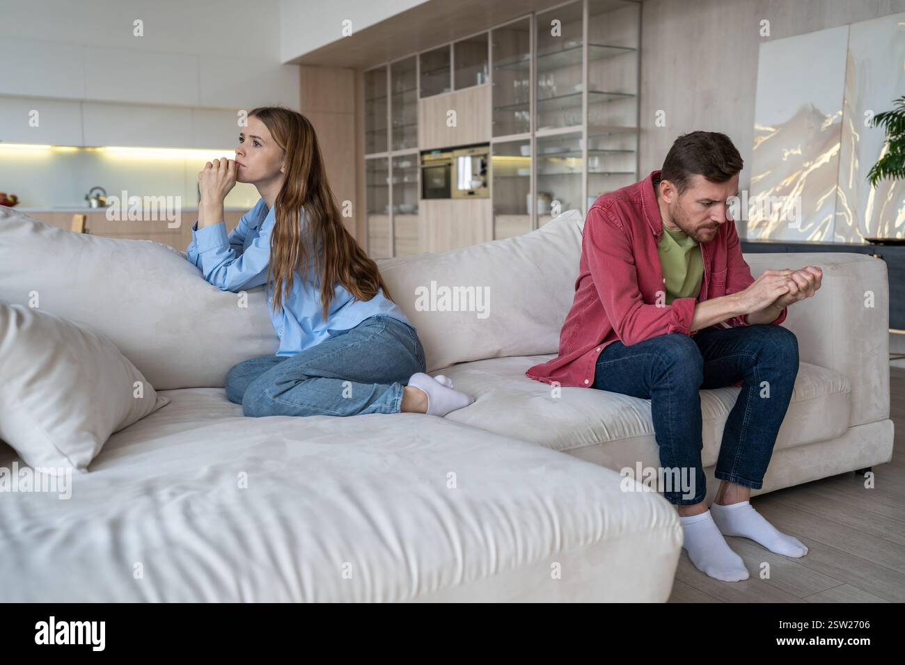 Sad unhappy married couple in quarrel sitting on sofa couch in living ...