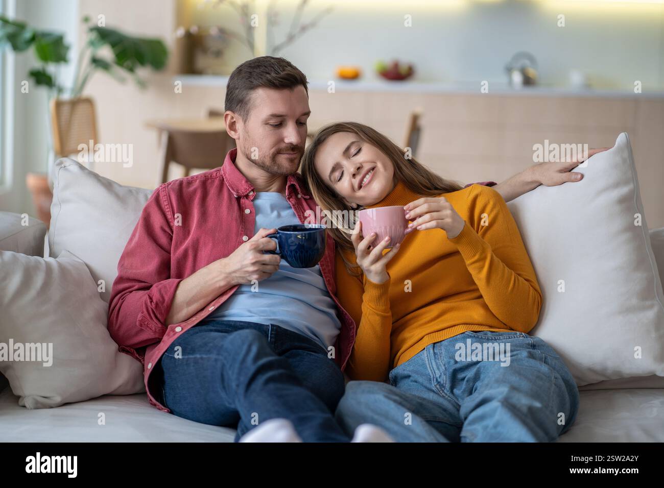 Husband and wife resting bonding at home enjoying weekend hi-res stock ...