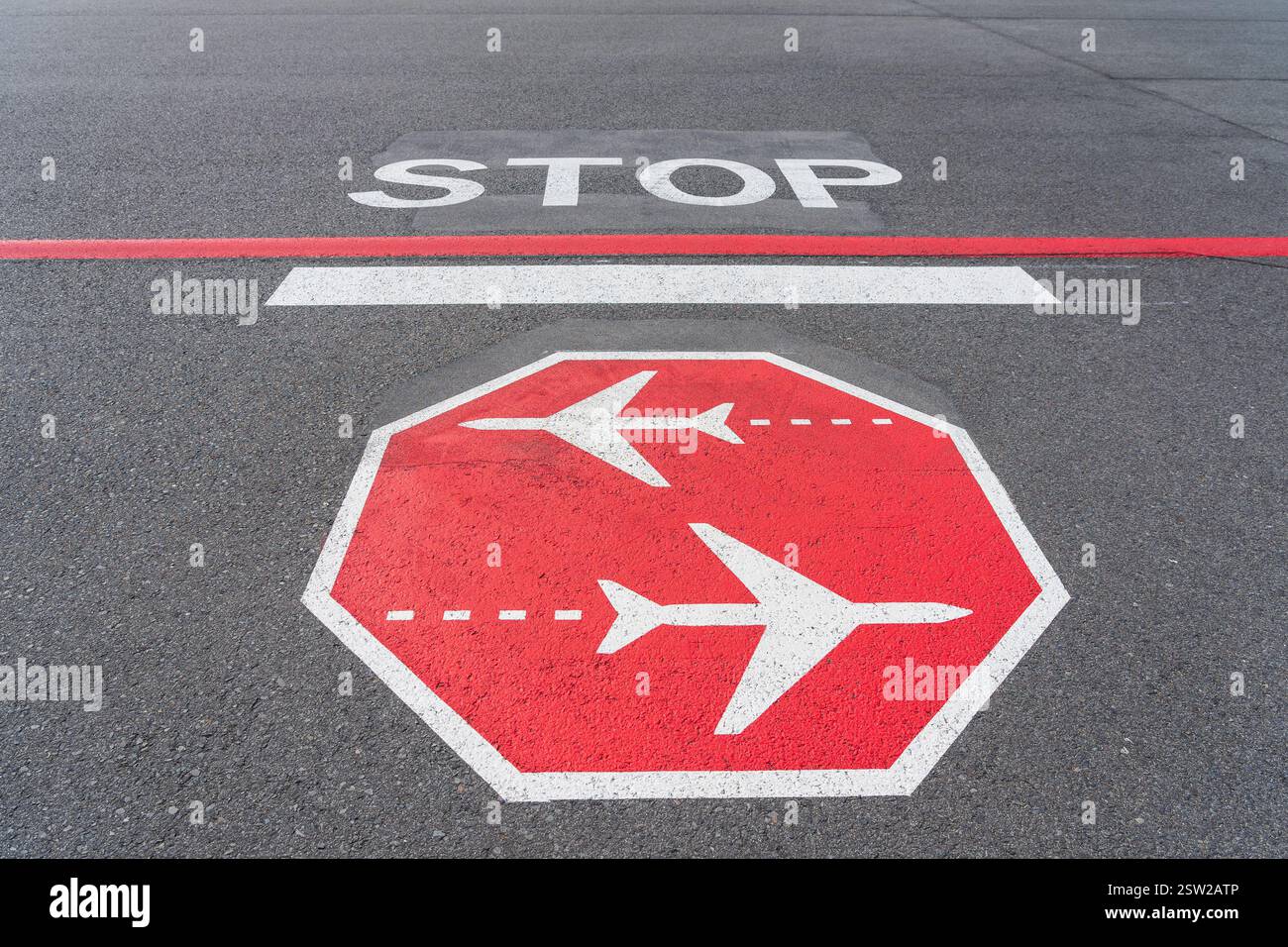 Road sign on the airfield asphalt. Stop line and image of an airplane ...
