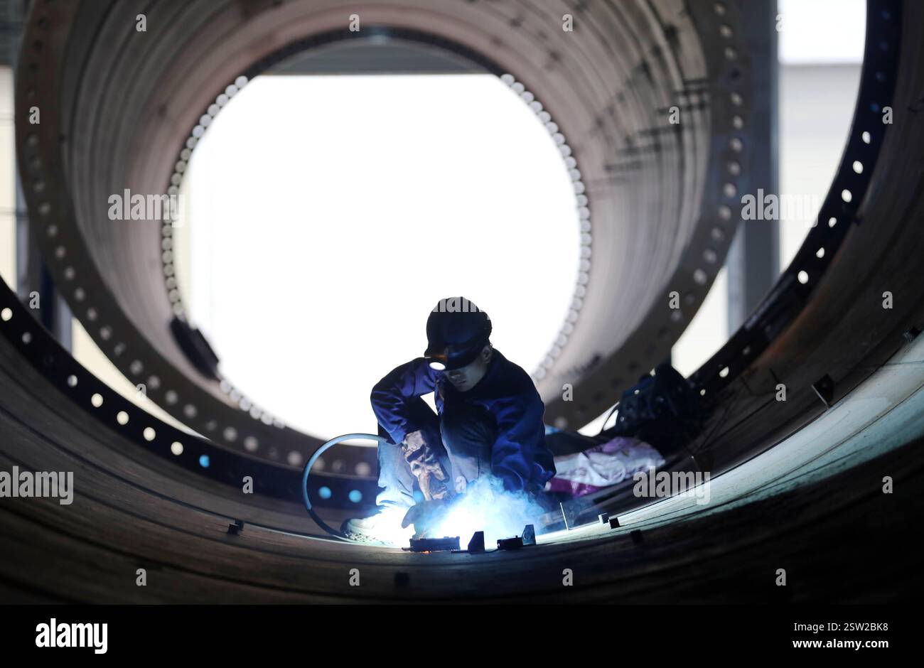 A worker performs ring joint welding on a tower cylinder in Liuzhou ...