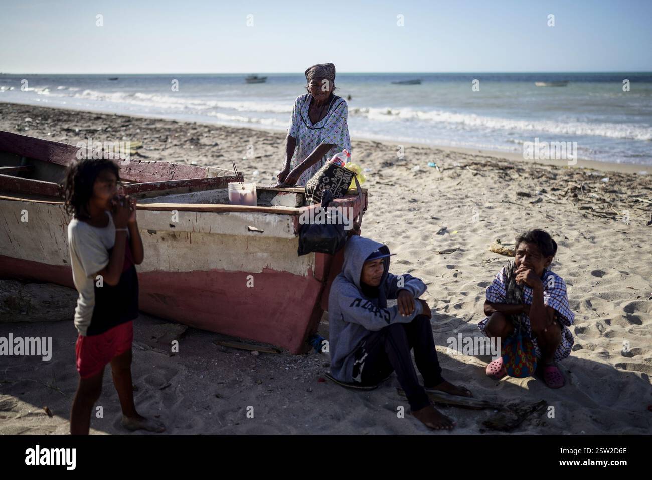 A family of fishers, of the Wayuu Indigenous group, meet on the beach ...