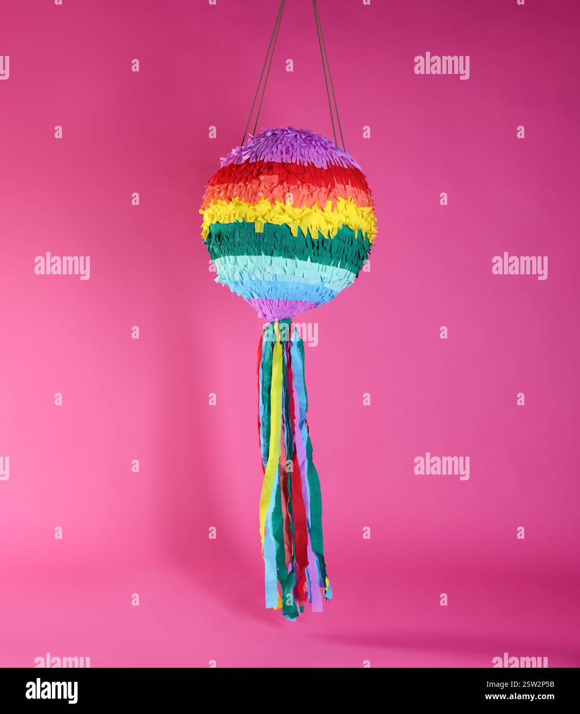 One colorful pinata on bright pink background Stock Photo - Alamy
