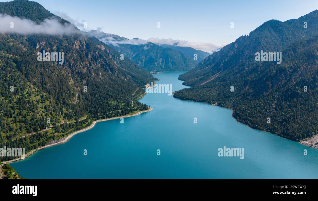 Explore the serene beauty of Plansee Lake in Austria surrounded by majestic mountains Stock ...