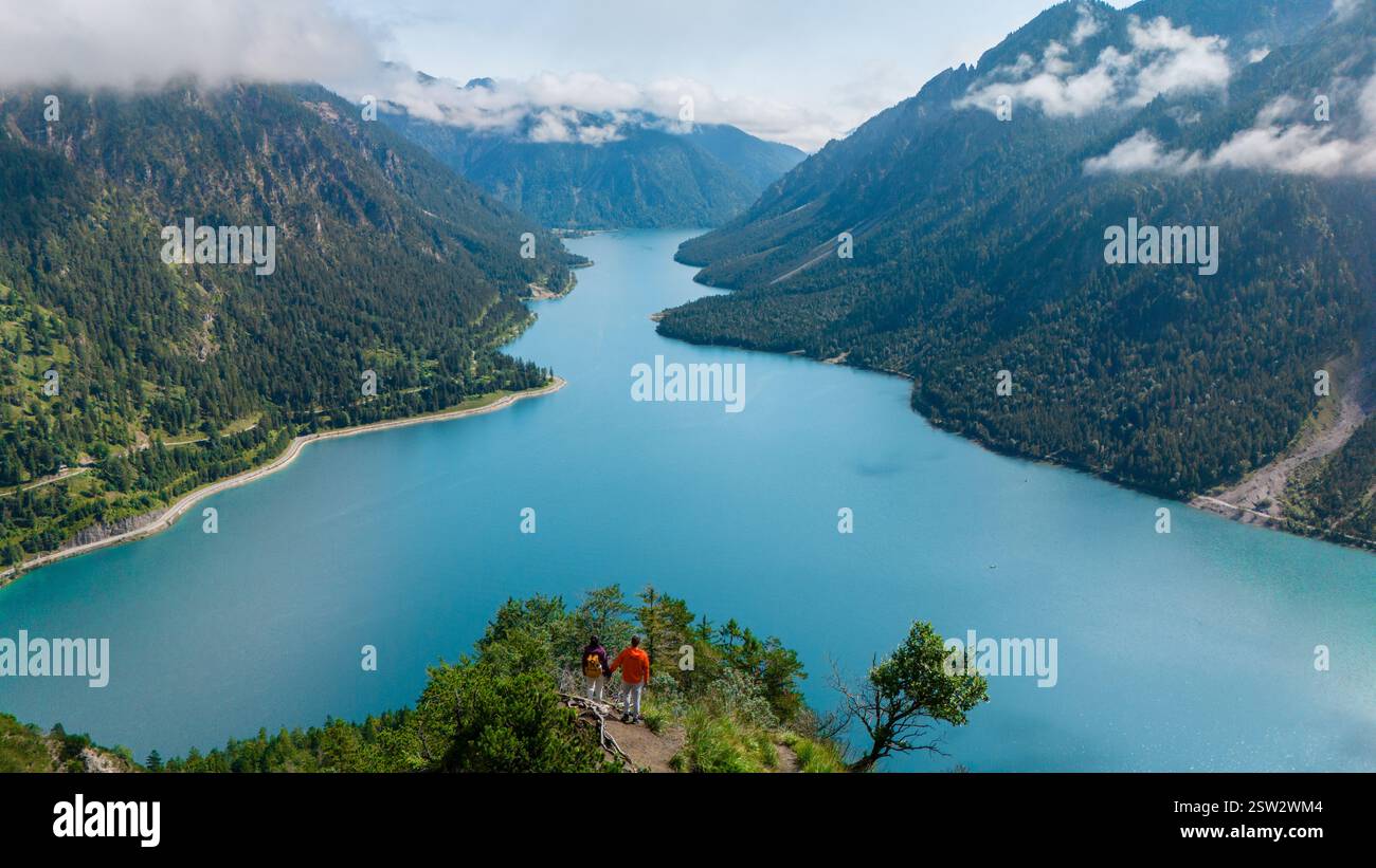 Breathtaking view of Plansee lake in Austria with hikers admiring the ...