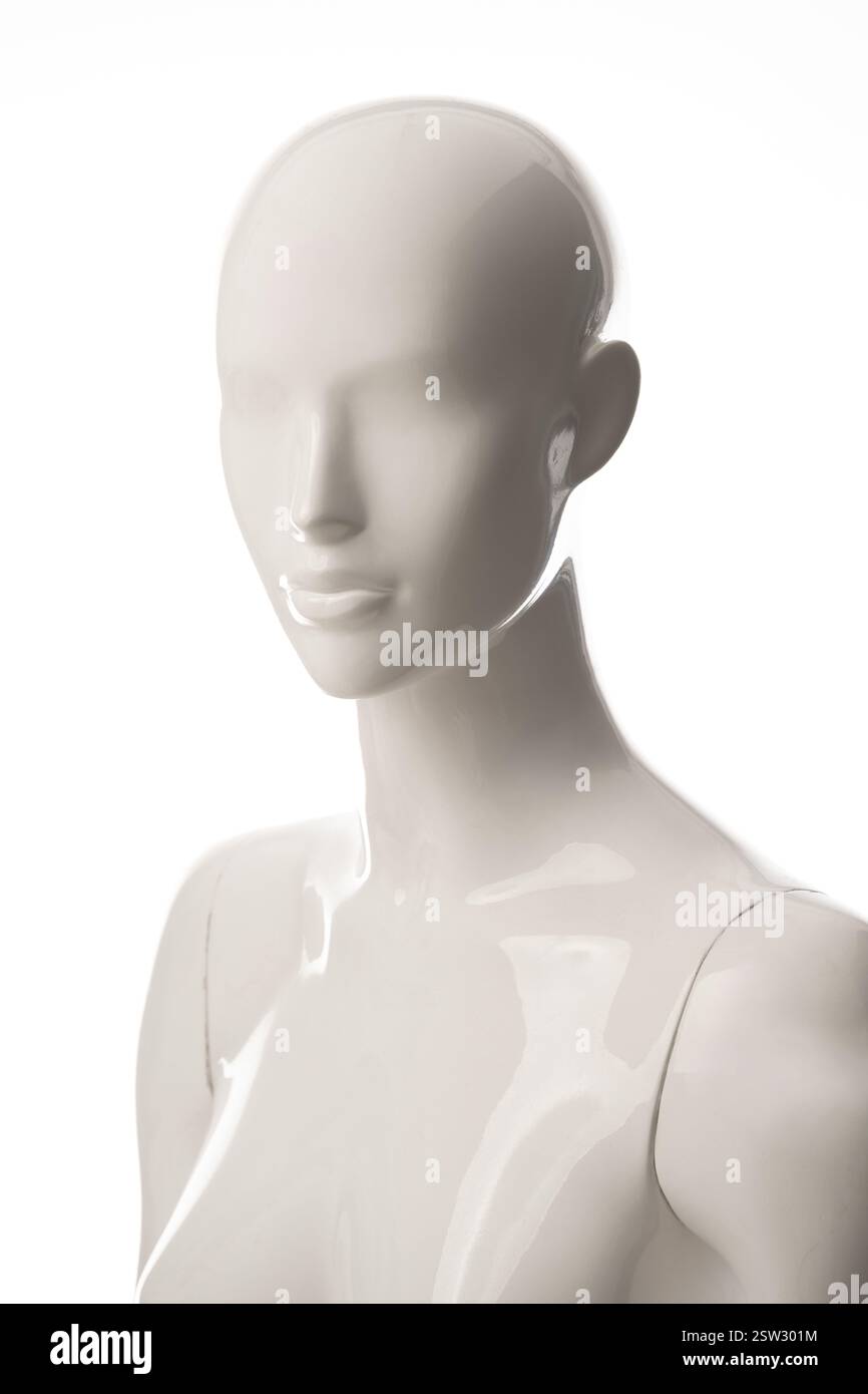A white mannequin stands in a well-lit area, emphasizing modern fashion ...