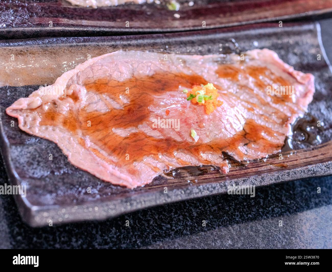 Wagyu beef sushi topped with orange ebiko Stock Photo - Alamy