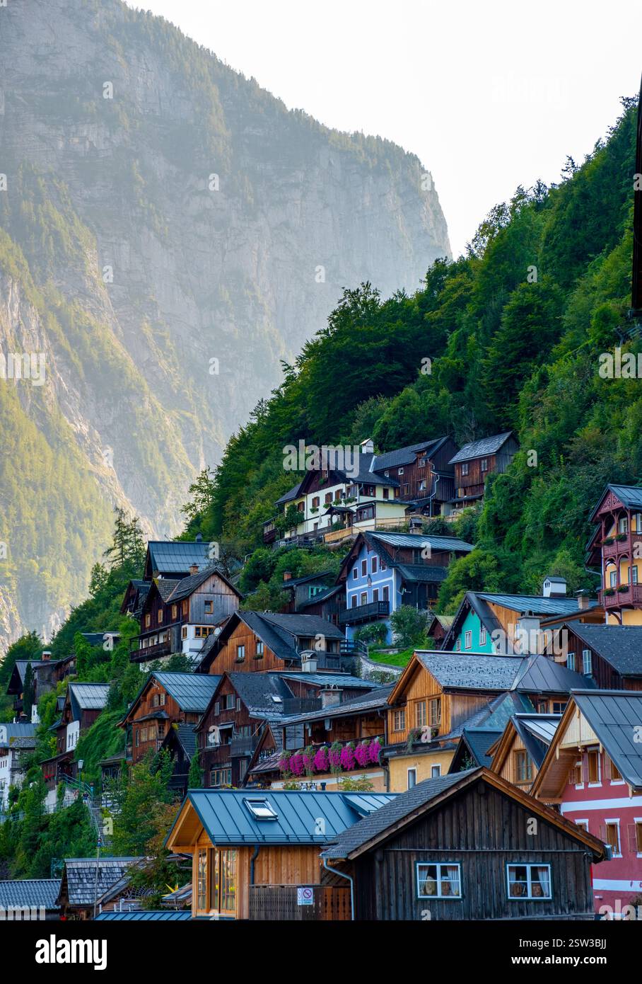 Colorful wooden homes cling to the hillside of Hallstatt, Austria ...
