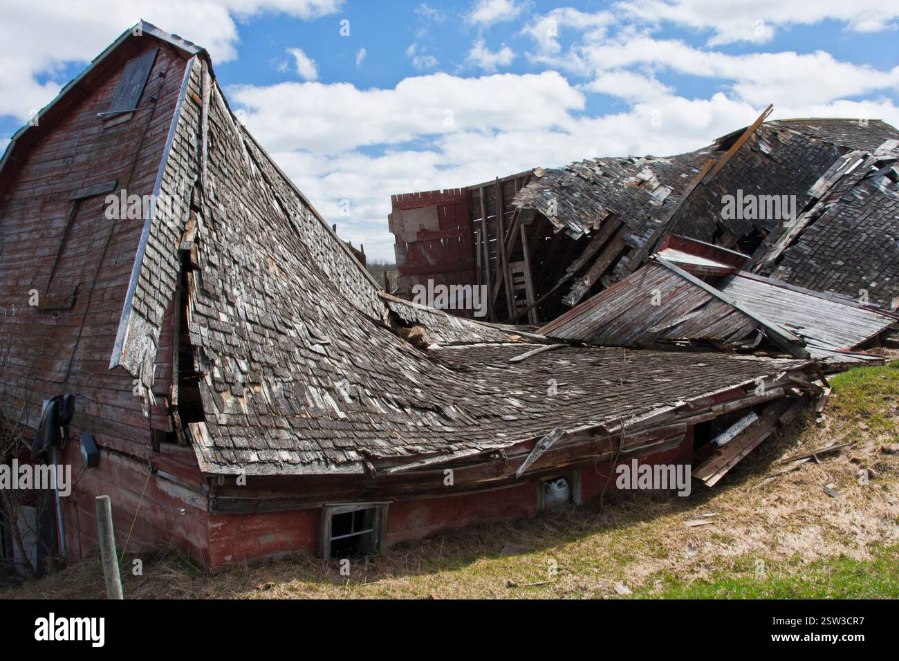 Barn has been destroyed by a storm. The roof is missing and the ...
