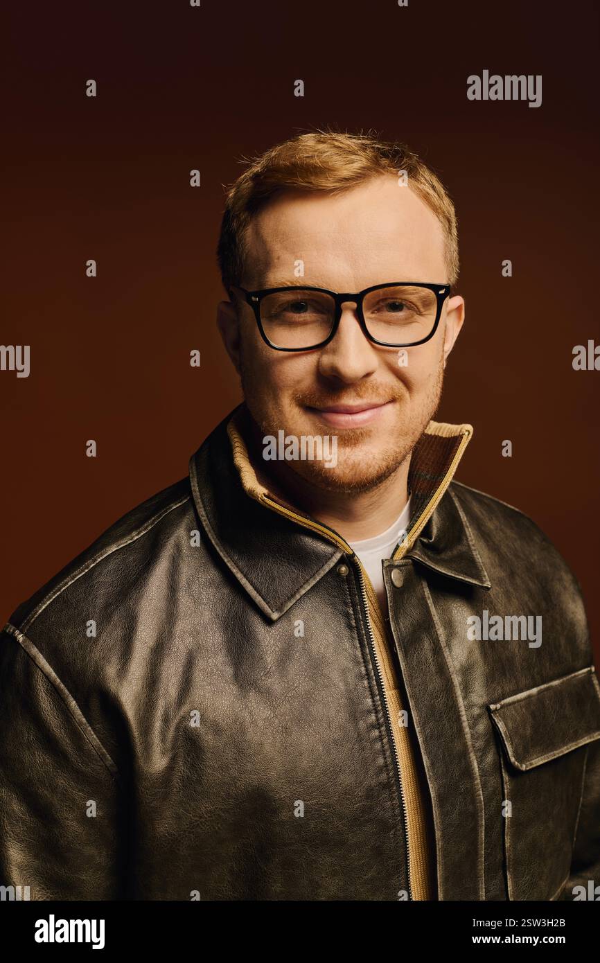 A good-looking man in casual attire confidently poses in a creative ...