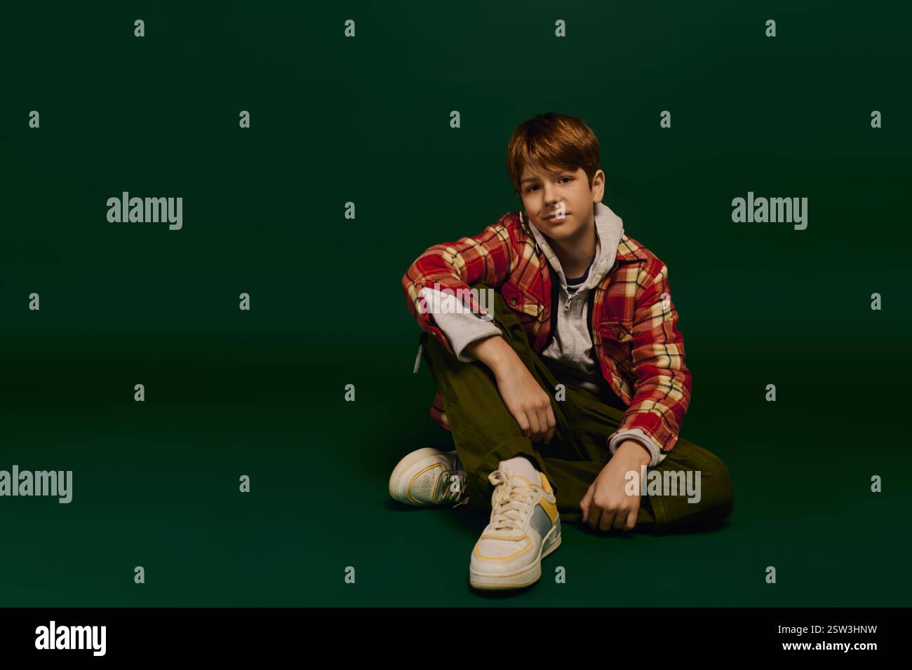 Casual outfit combines stylish checkered patterns as the boy poses ...