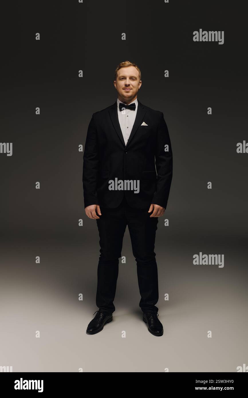 A handsome man dressed in formal attire stands poised, exuding ...