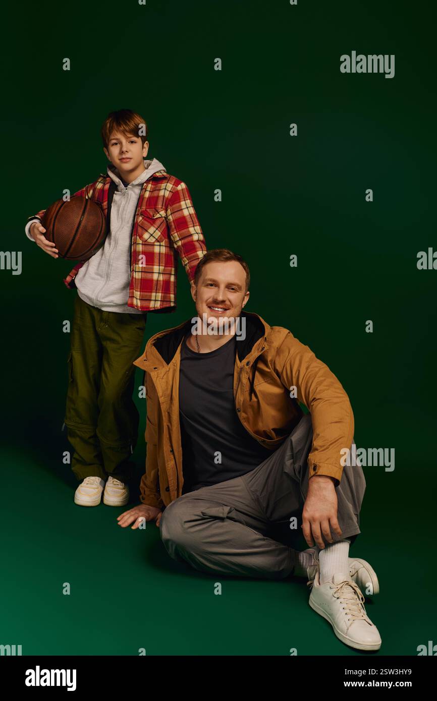 Father and son share a playful smile while showcasing their casual ...