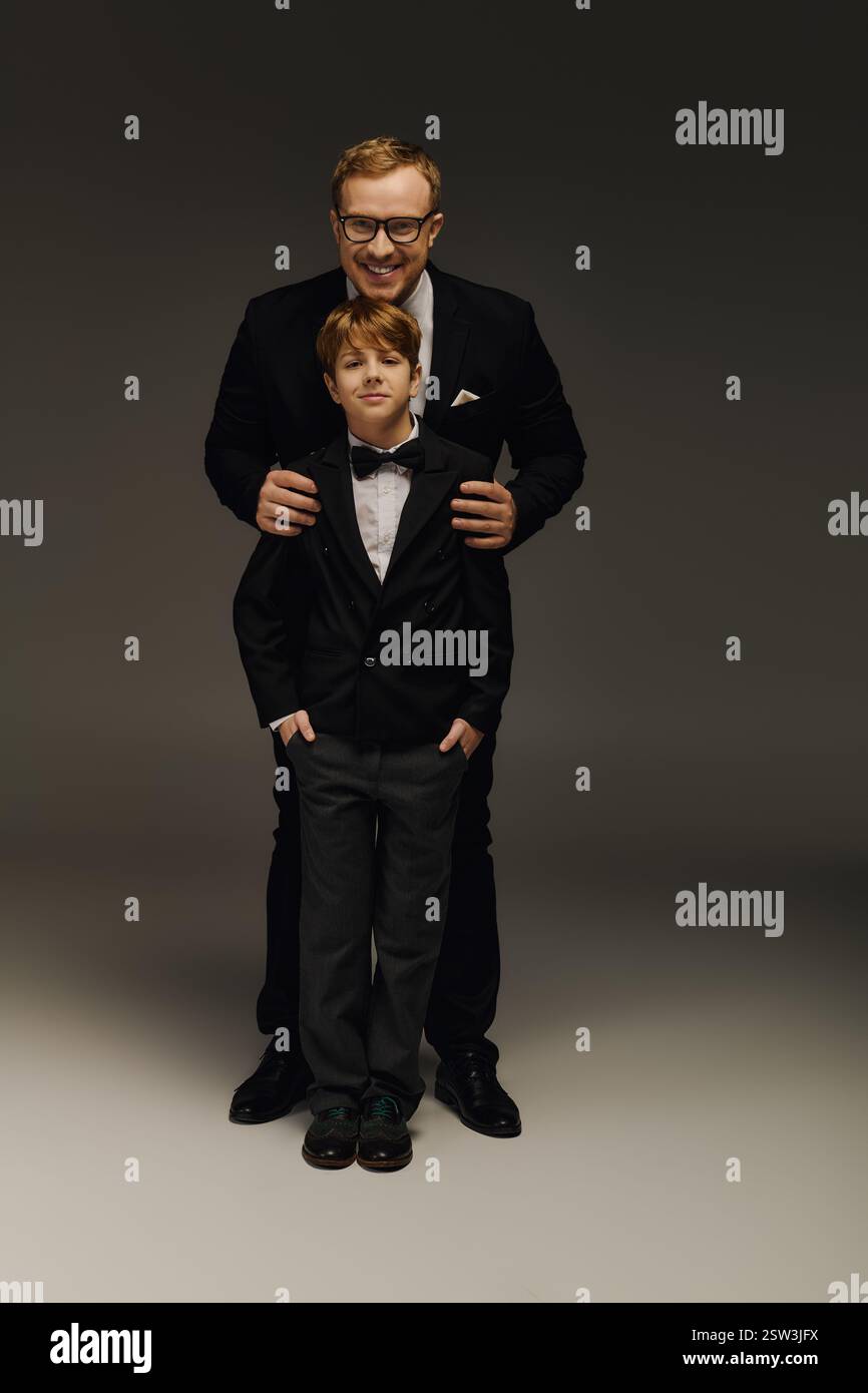 Handsome father and son pose together in elegant bow ties, displaying a ...