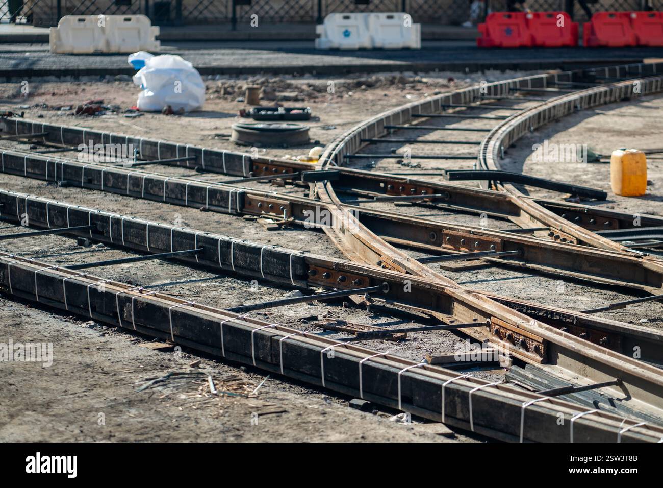 Major tram track overhaul on closed city street. Rail junction with beams, tools awaiting ...
