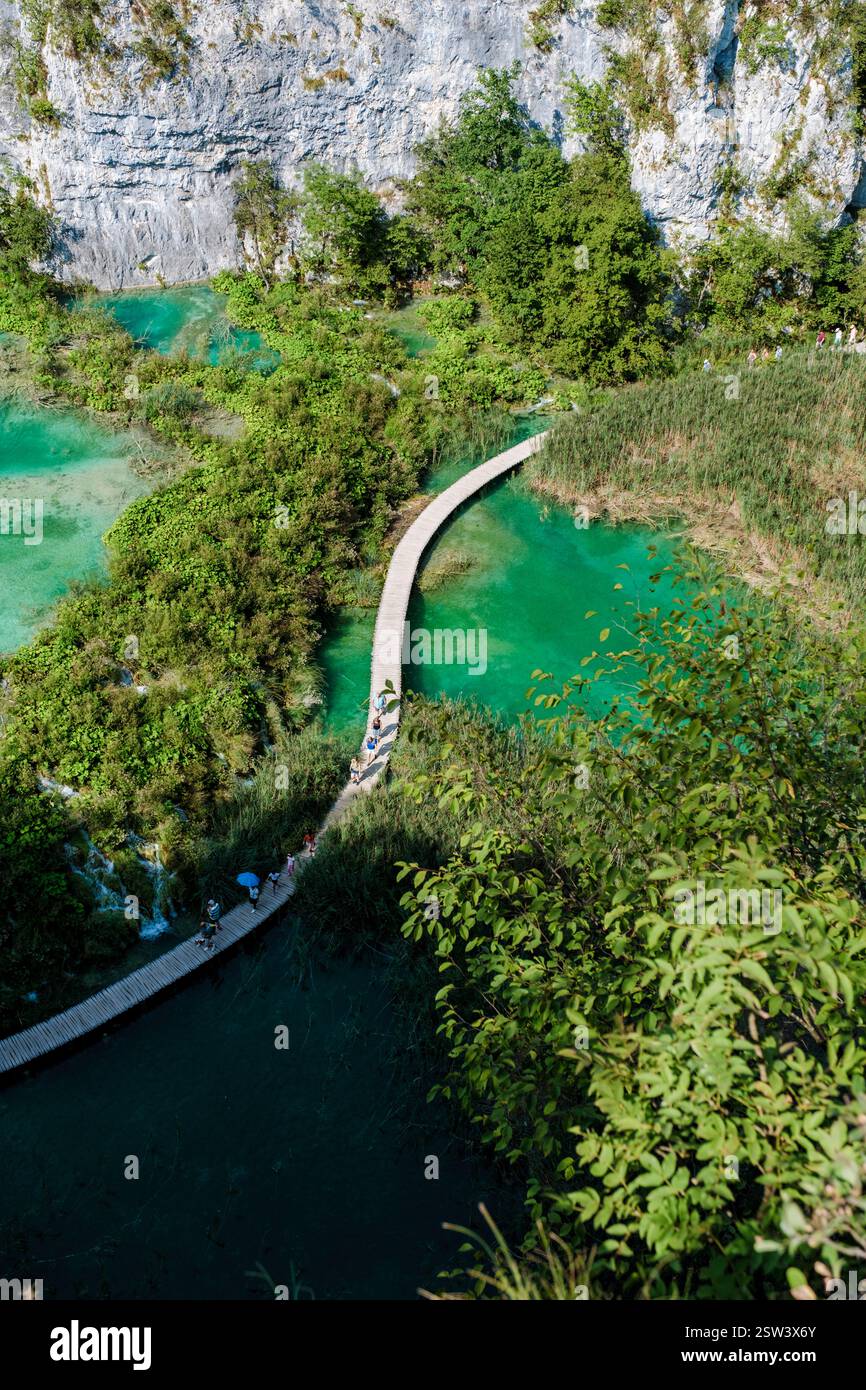 Winding wooden pathways meander through vibrant turquoise waters and ...