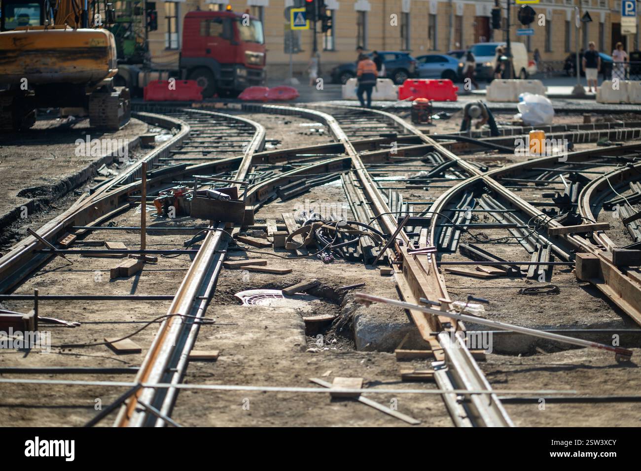 Construction site with scattered beams and rails, major tram track and ...