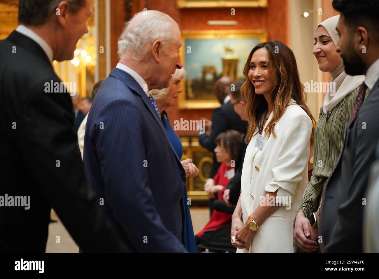 King Charles III meets Mylene Klass during a reception celebrating ...