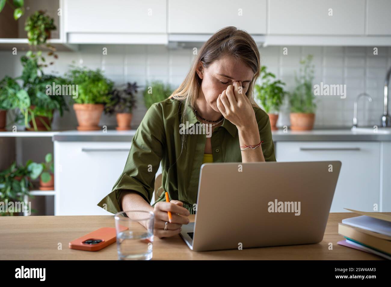 Stressed woman feeling exhausted of overtime work, realizing failure to keep to task deadline ...