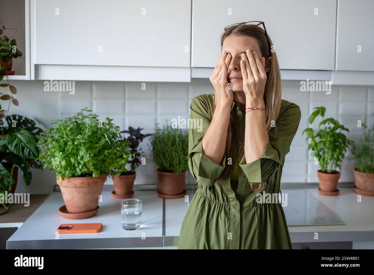 Sleepy tired woman suffering from insomnia rubbing eyes on kitchen with ...