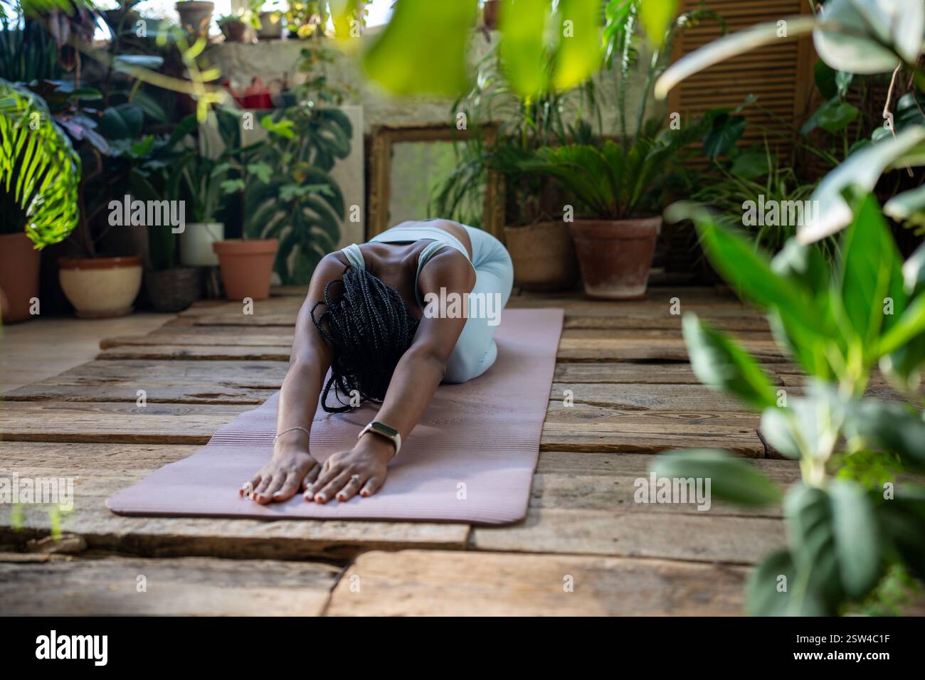 Sported black woman doing stretching exercise for back flexibility ...
