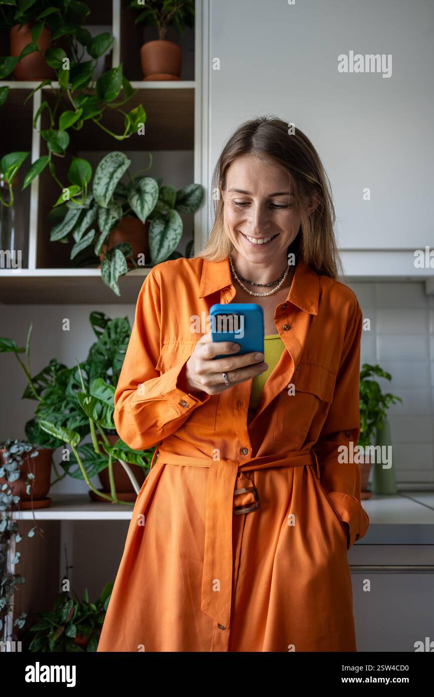 Happy confident Scandinavian woman chatting in smartphone typing ...