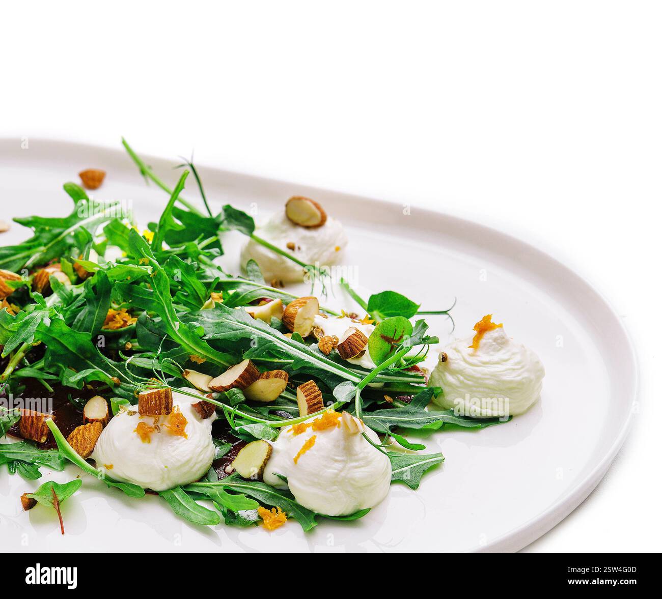 Arugula salad with raw almond slices and burrata cheeses Stock Photo ...
