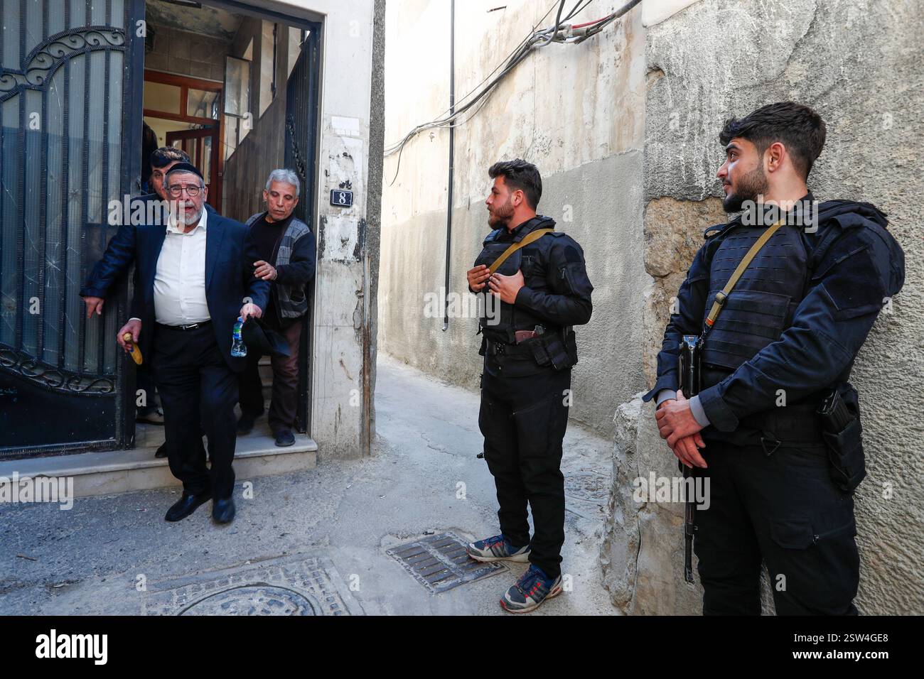 Rabbi Yusuf Hamra, left, leaves after visiting a Jewish school in the ...