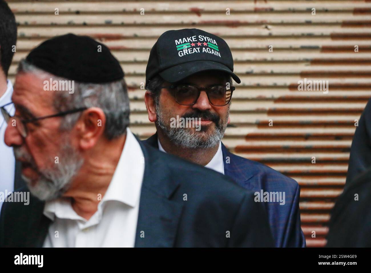 A man part of a Jewish-American delegation wears a baseball hat during ...