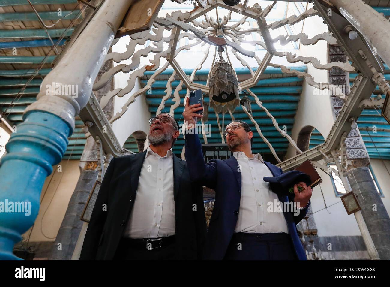 Rabbi Yusuf Hamra, left, and his son Henry take pictures as they visit ...