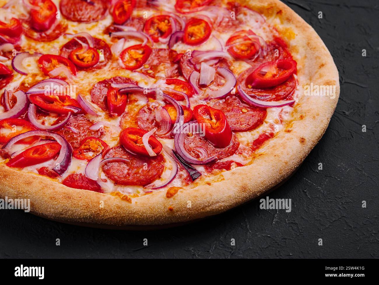Tasty pepperoni pizza with red chili pepper and onion Stock Photo - Alamy
