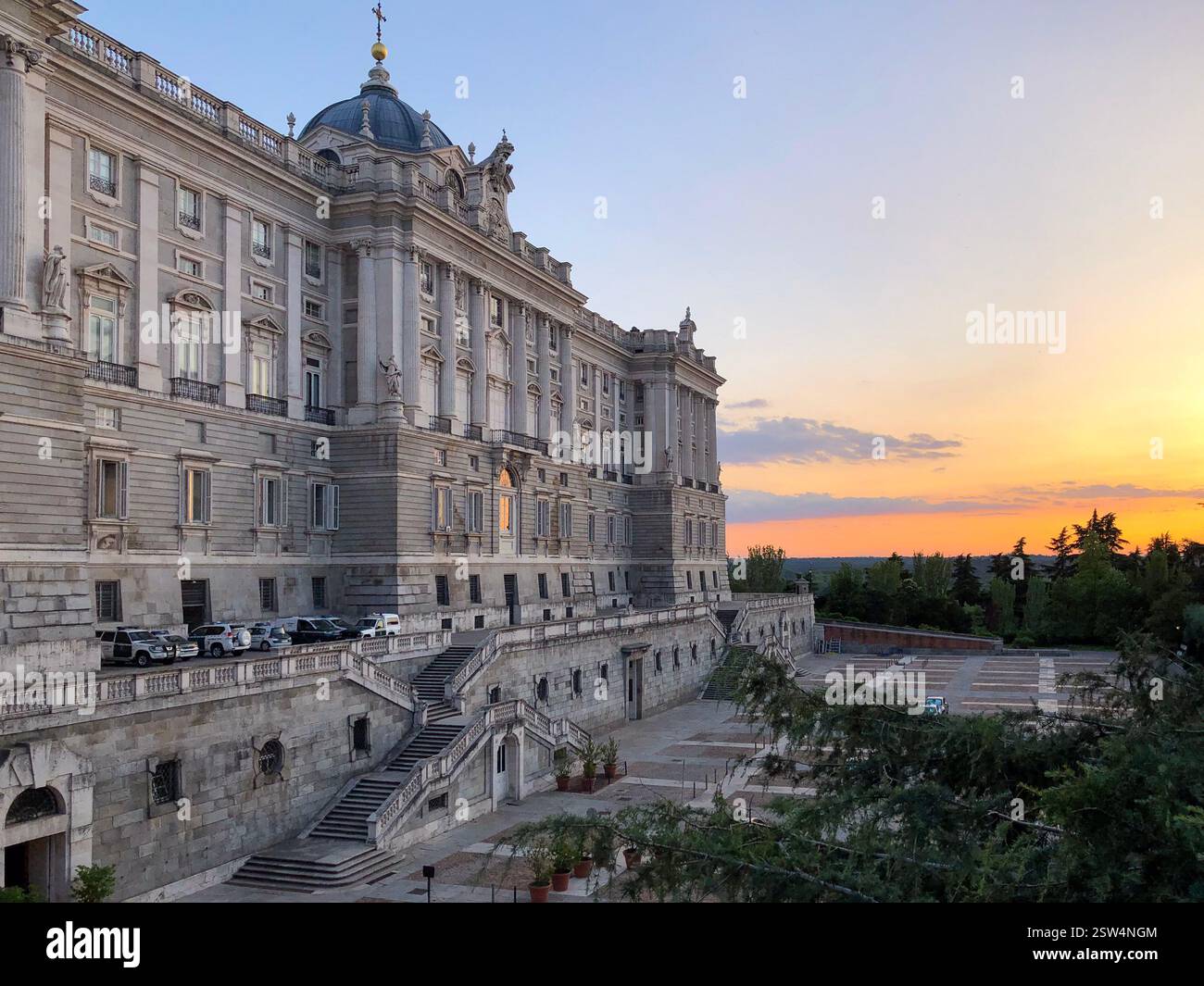 The Royal Palace of Madrid at sunset, showcasing its grand architecture ...