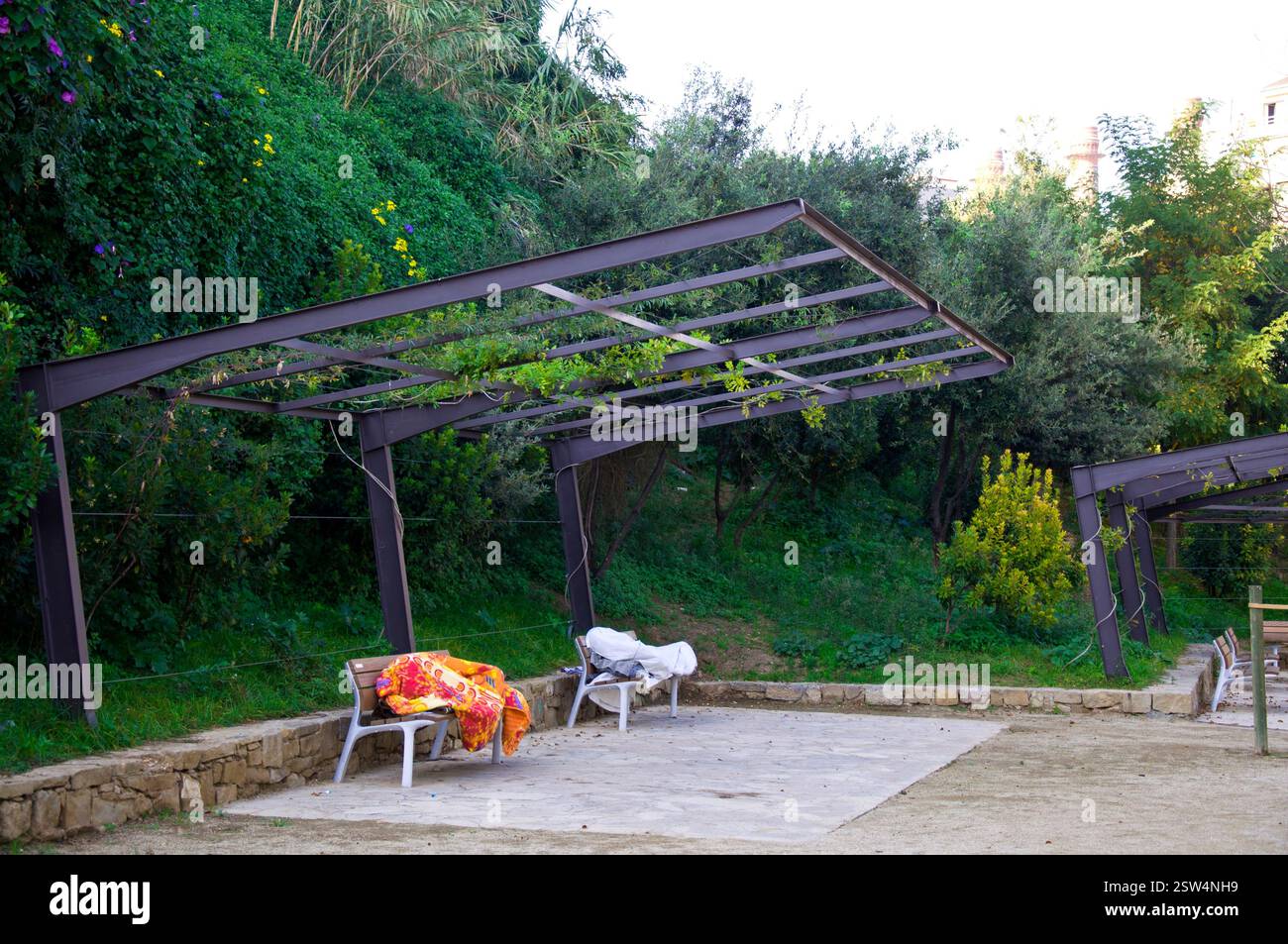 Homeless sleeping on benches covered with blankets, Parc de Montjuic ...