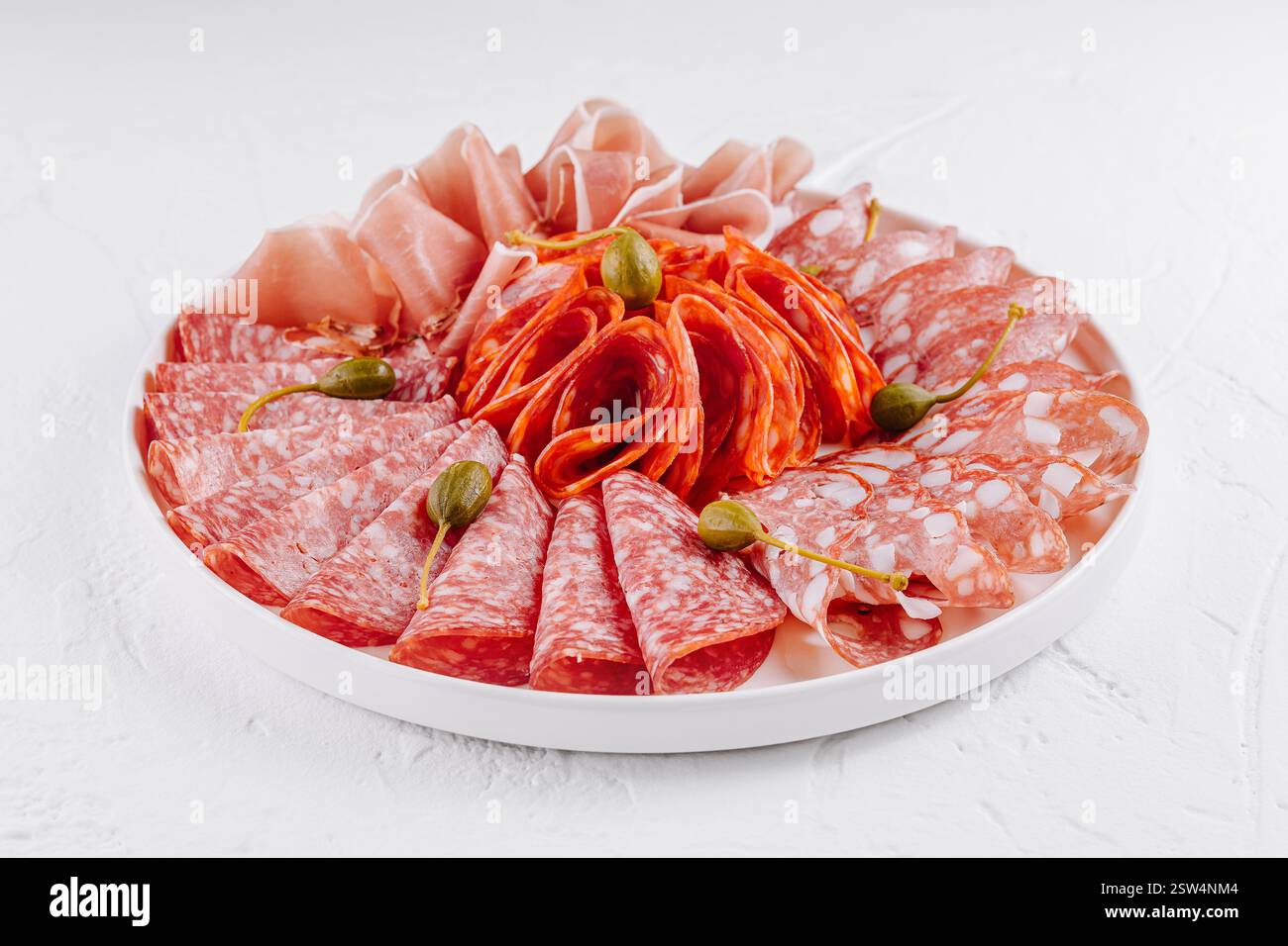 Assorted deli meat platter on white background Stock Photo - Alamy