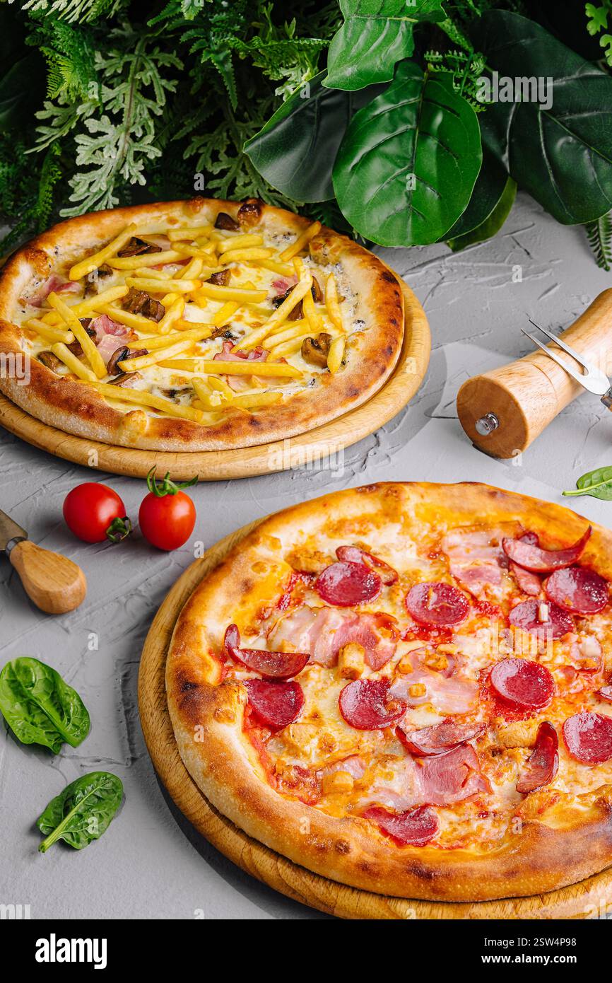Gourmet pizzas with toppings on elegant table setting Stock Photo - Alamy