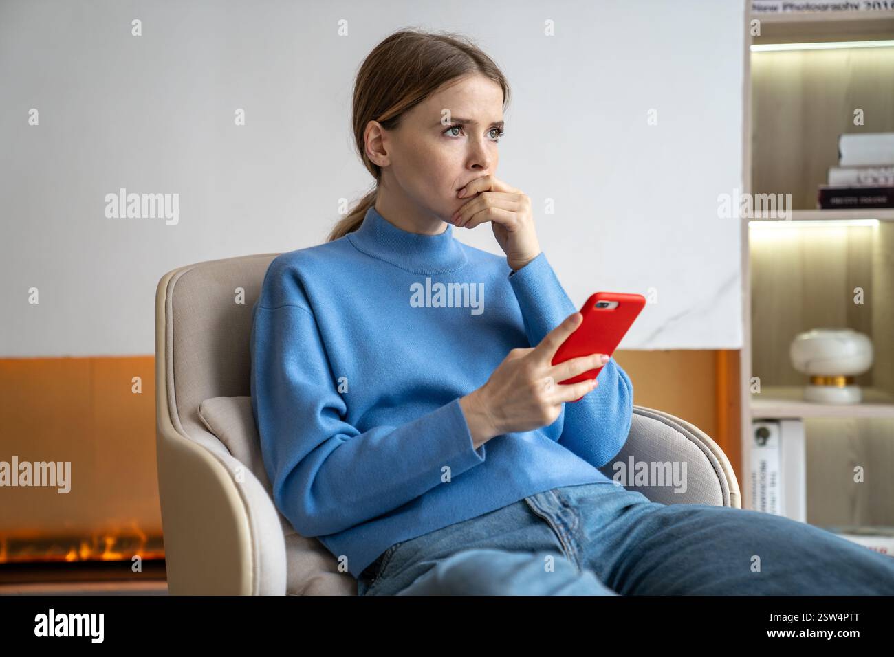 Confused busy woman holding smartphone, thinking over work and ...